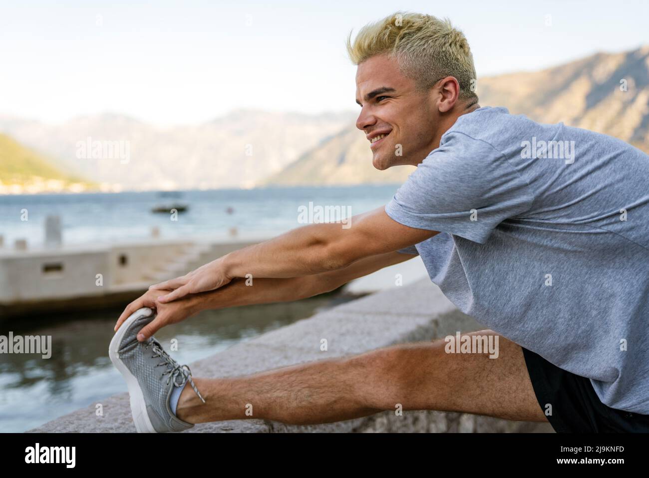Strong young man stretching muscles hi-res stock photography and images ...