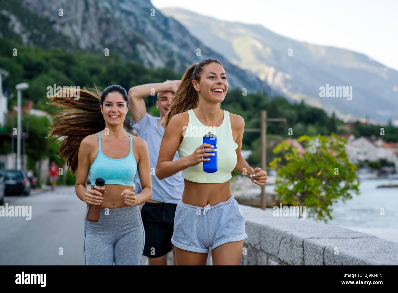Group of cheerful fit fitness friends team exercising together outdoor ...
