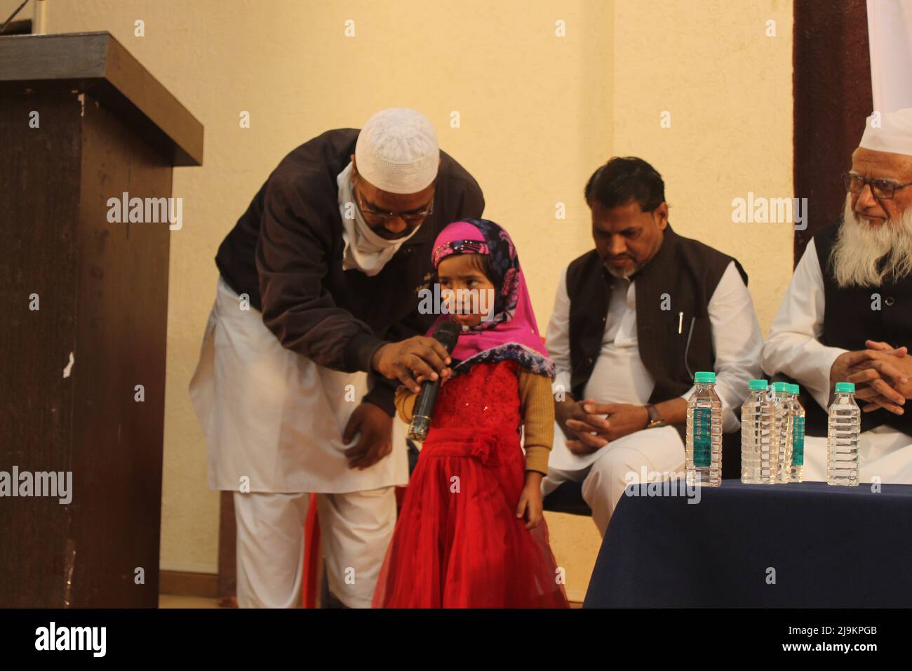 Muslim man giving a speech on a pedestal in front of an audience Stock ...