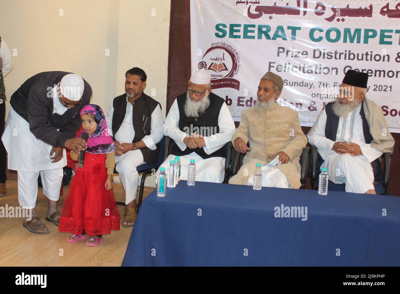 Muslim man giving a speech on a pedestal in front of an audience Stock ...