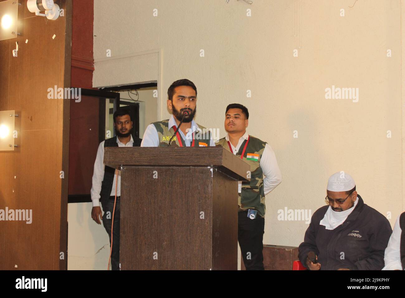 Muslim man giving a speech on a pedestal in front of an audience Stock ...