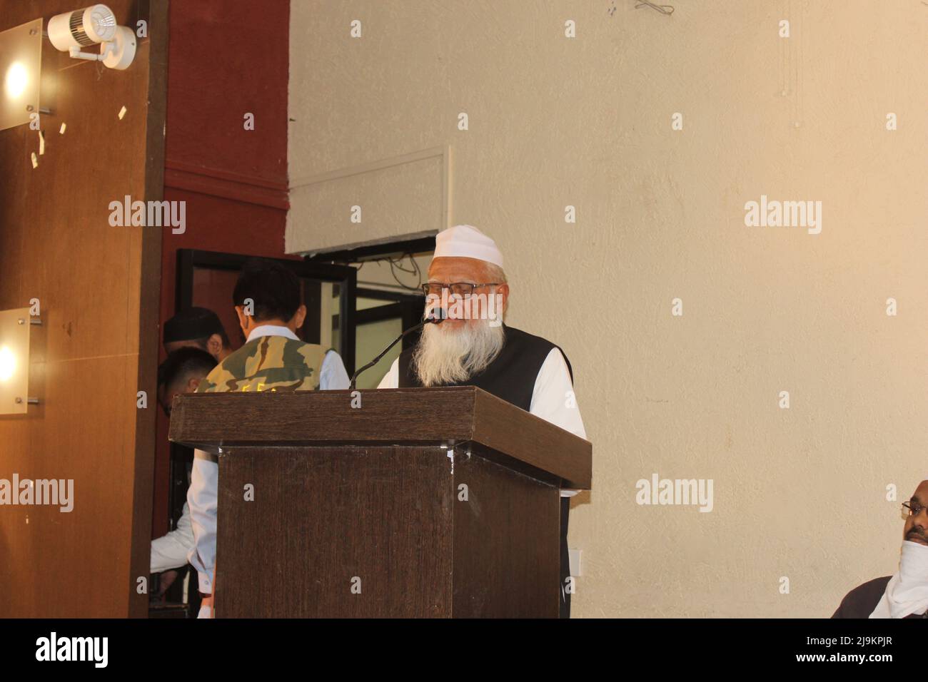 Muslim man giving a speech on a pedestal in front of an audience Stock ...