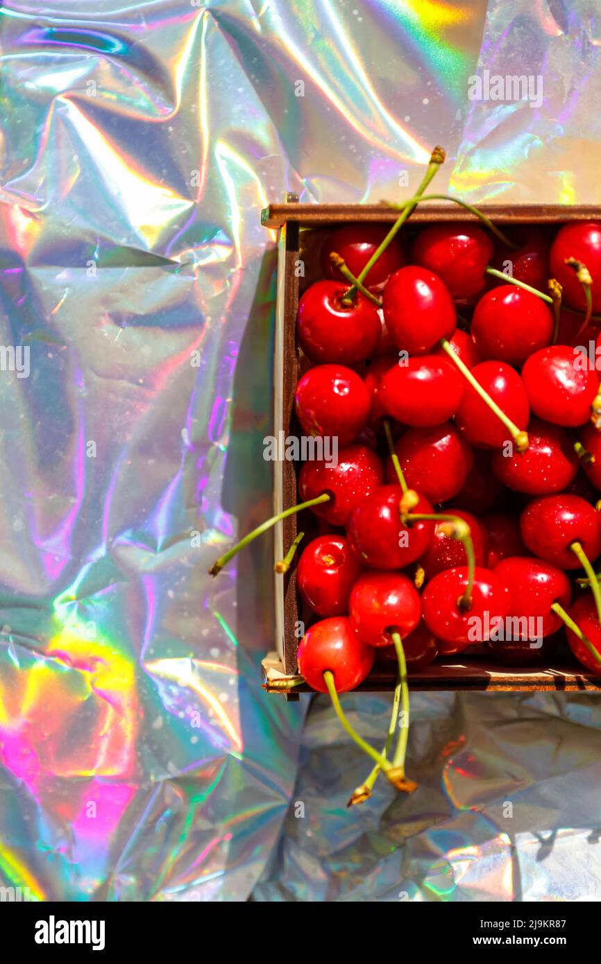 Defocus close-up cropped box, crape of dark red wet sweet cherries with ...