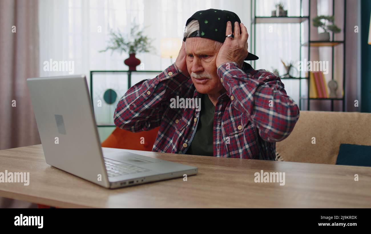 Stressed upset senior grandfather man working on laptop computer ...