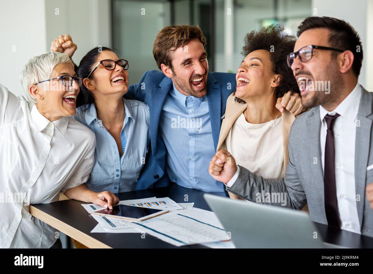Group of successful multiethnic business people celebrating a good job ...