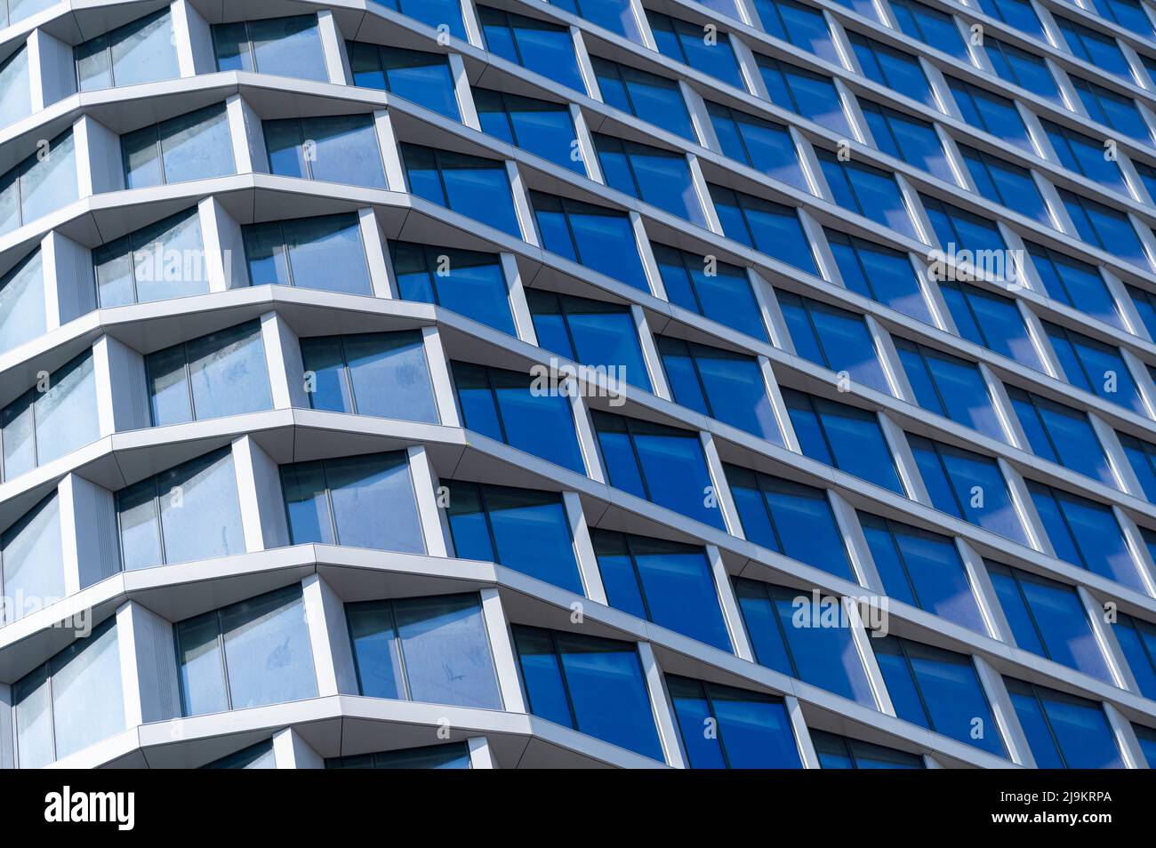 Modern building facade of glass and steele wirth a reflection of blue ...