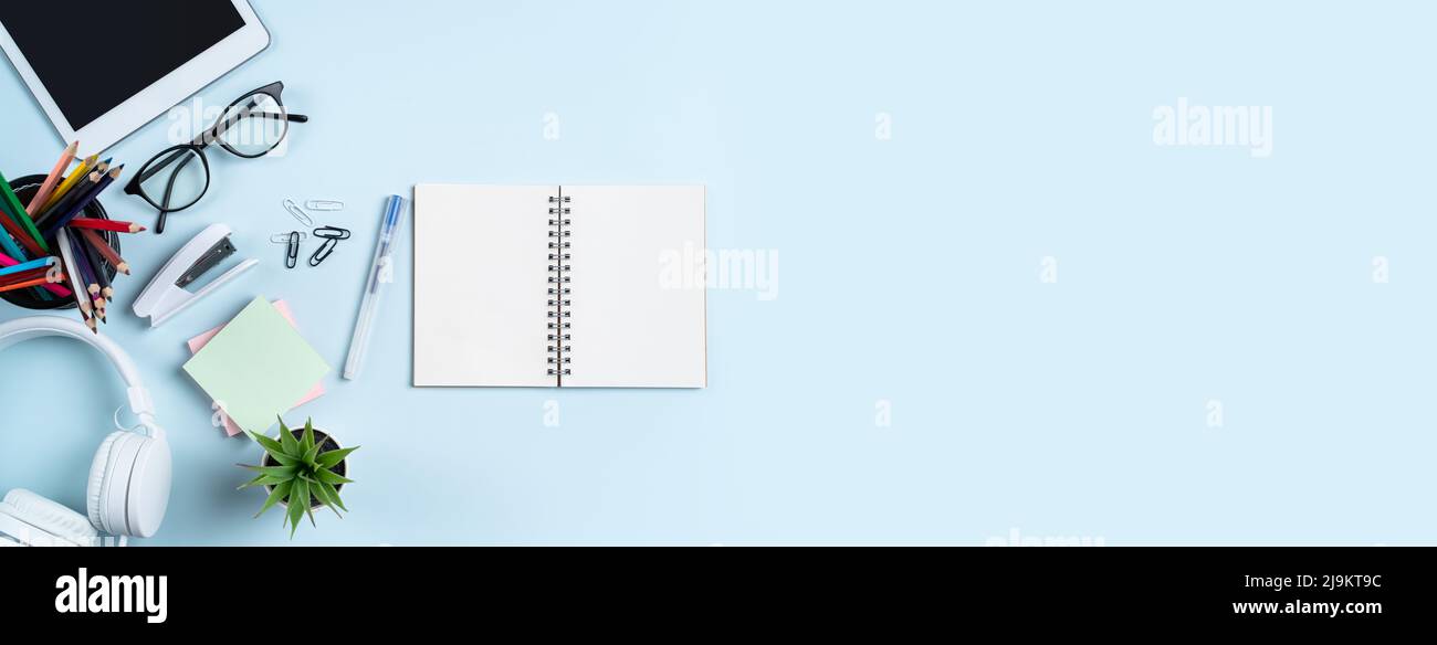 Online learning design concept. Top view of student table with tablet ...