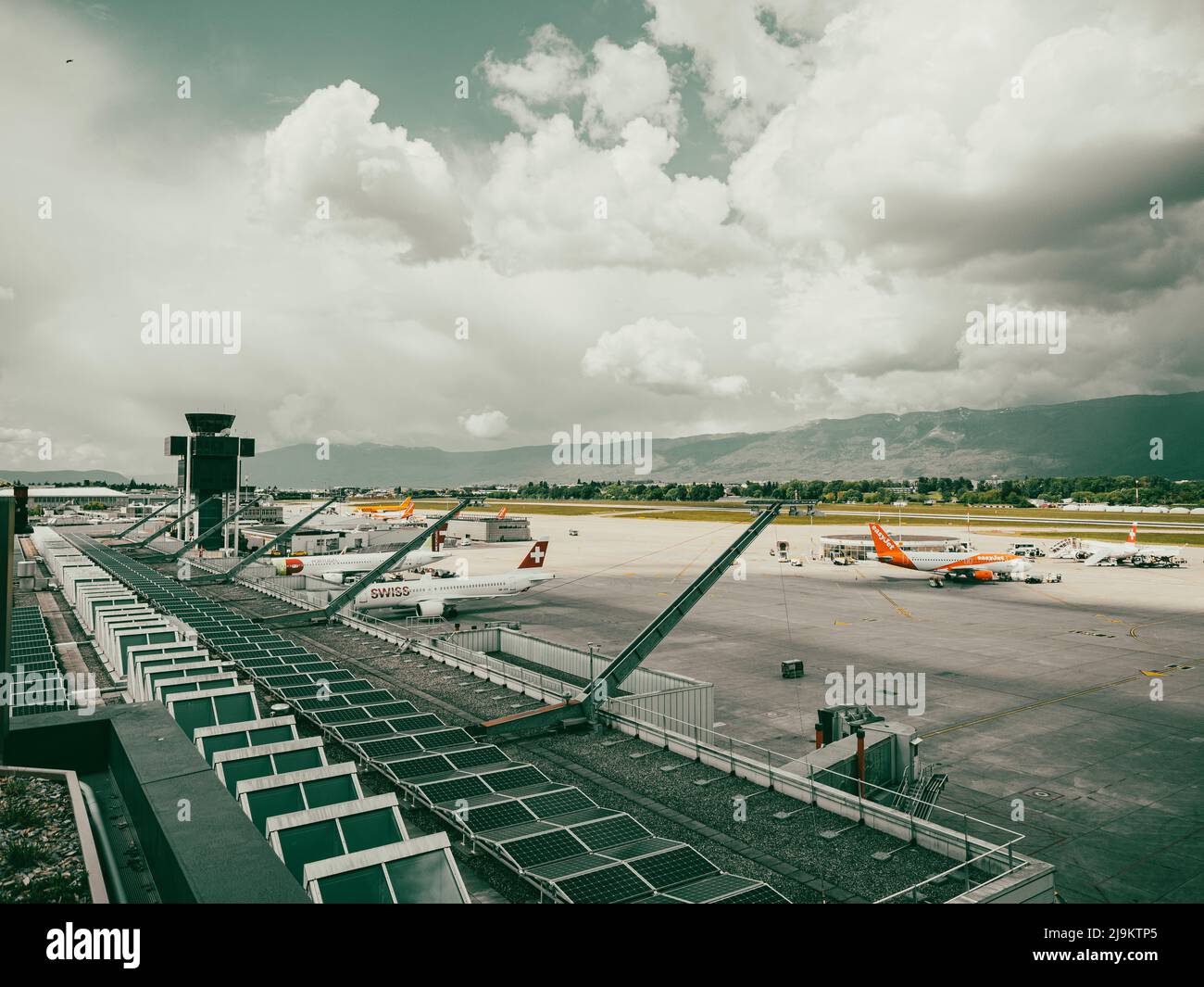 Airport of Geneva, Switzerland. Planes and service vehicles stand on ...