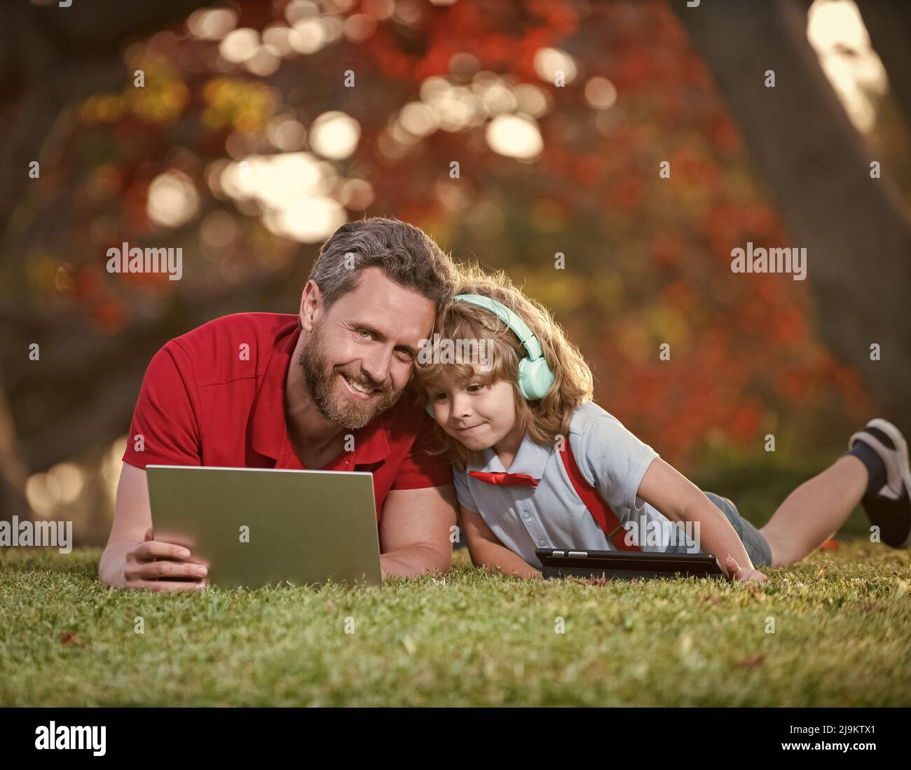 happy family of dad and son use laptop for lesson listen music in ...