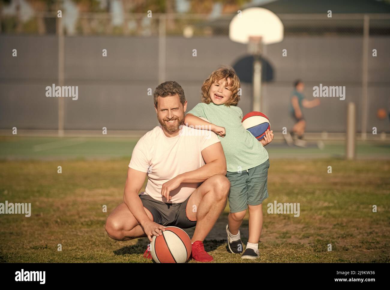 dad and kid boy hold sport ball. child play basketball. childhood and ...