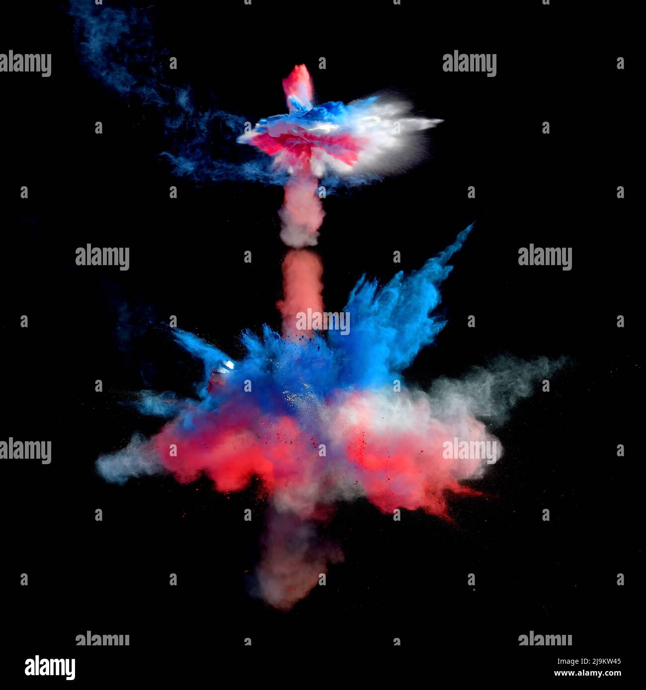 Red, white and blue forms of powder paint combined together explode in ...