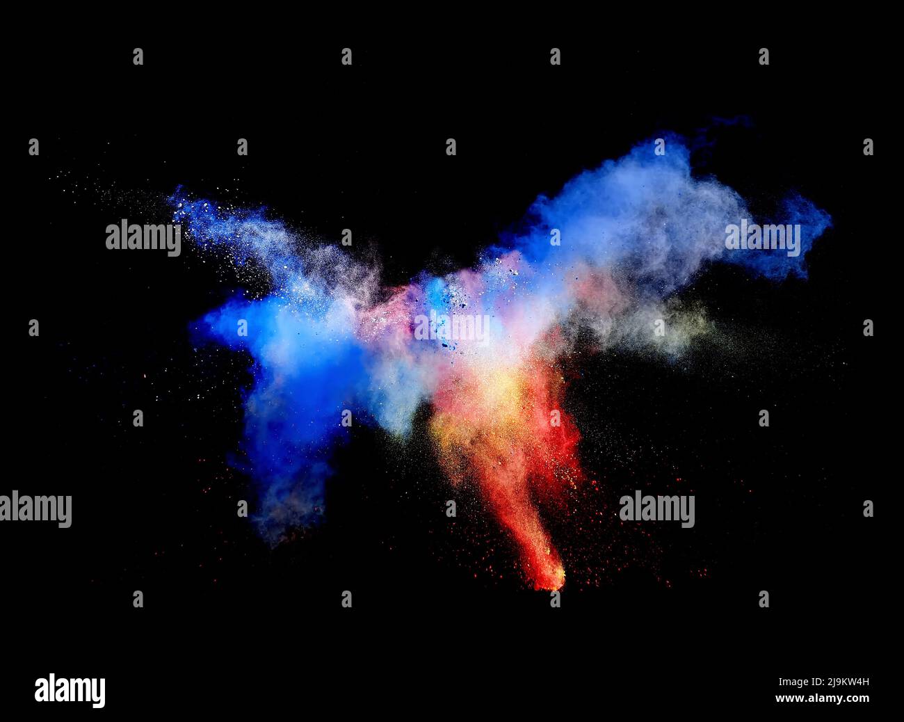 Red, white and blue forms of powder paint combined together explode in ...