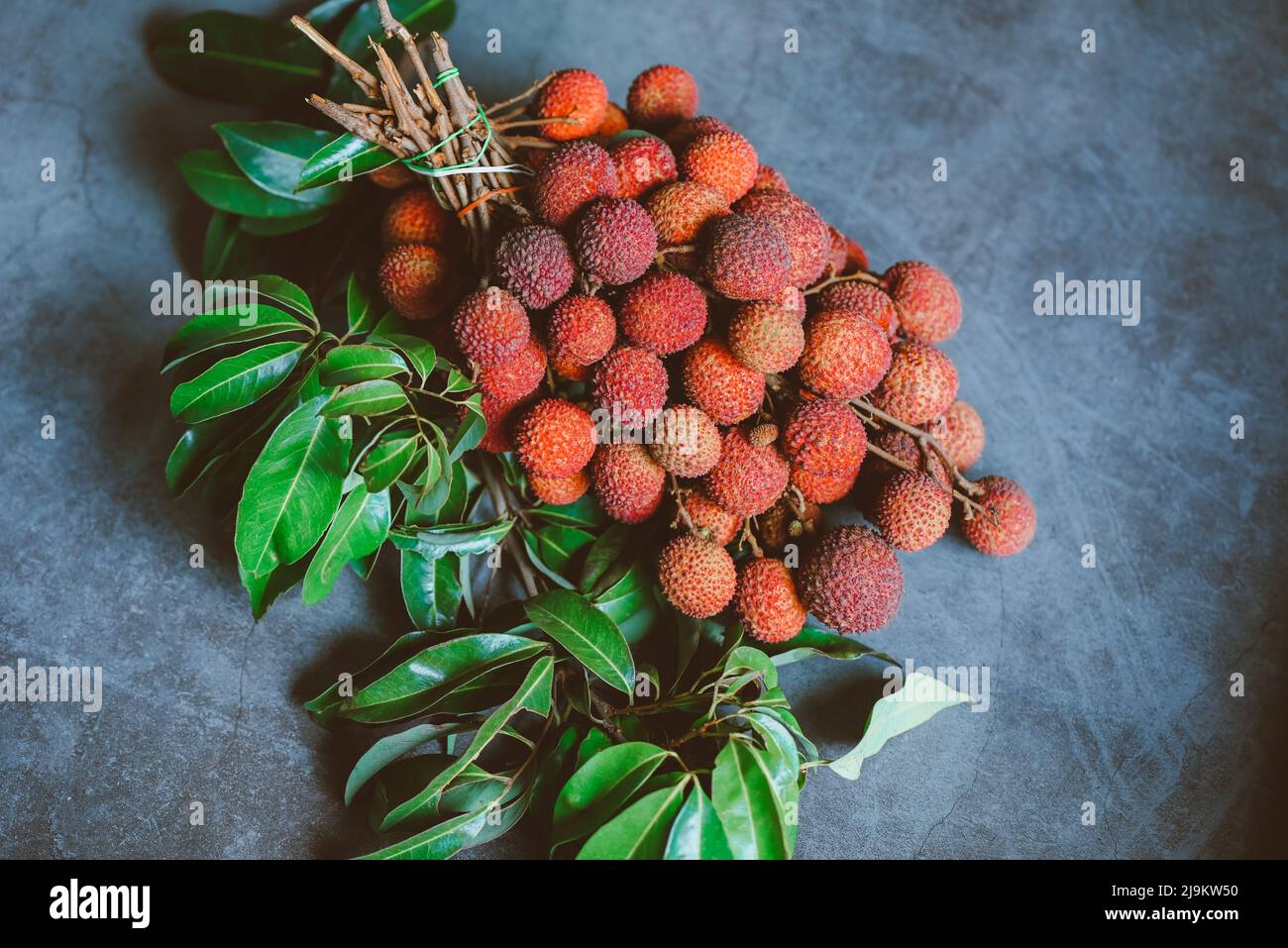 Lychee fruit with green leaf on black background, fresh ripe lychee ...