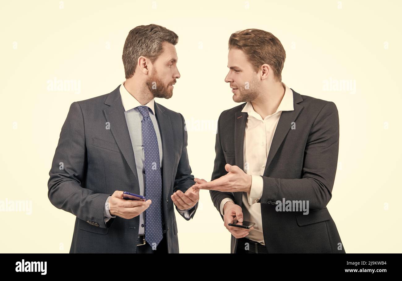 live communication. two colleagues discussing business hold phone ...