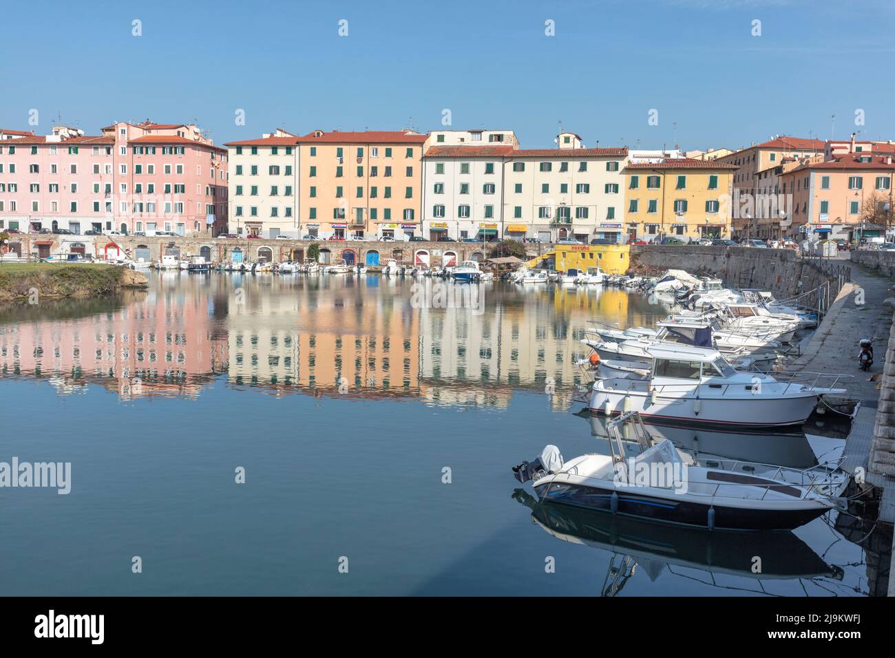 Boats moored in canal by Fortezza Nuova fortress and Via Scali della ...