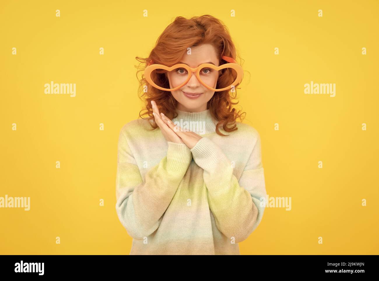 happy redhead woman wear funny party glasses on yellow background ...