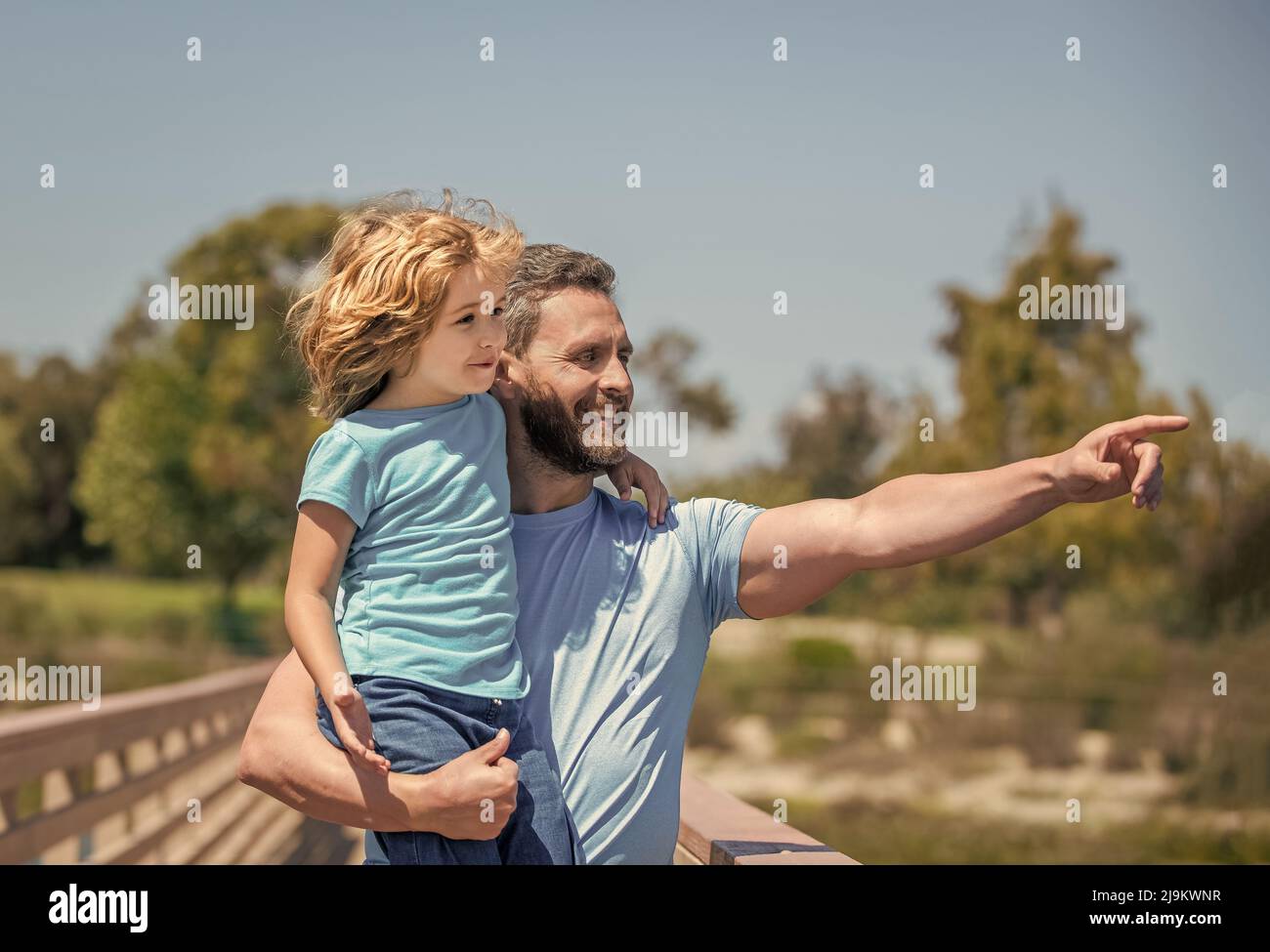 happy father directing showing something his child outdoor, childhood ...