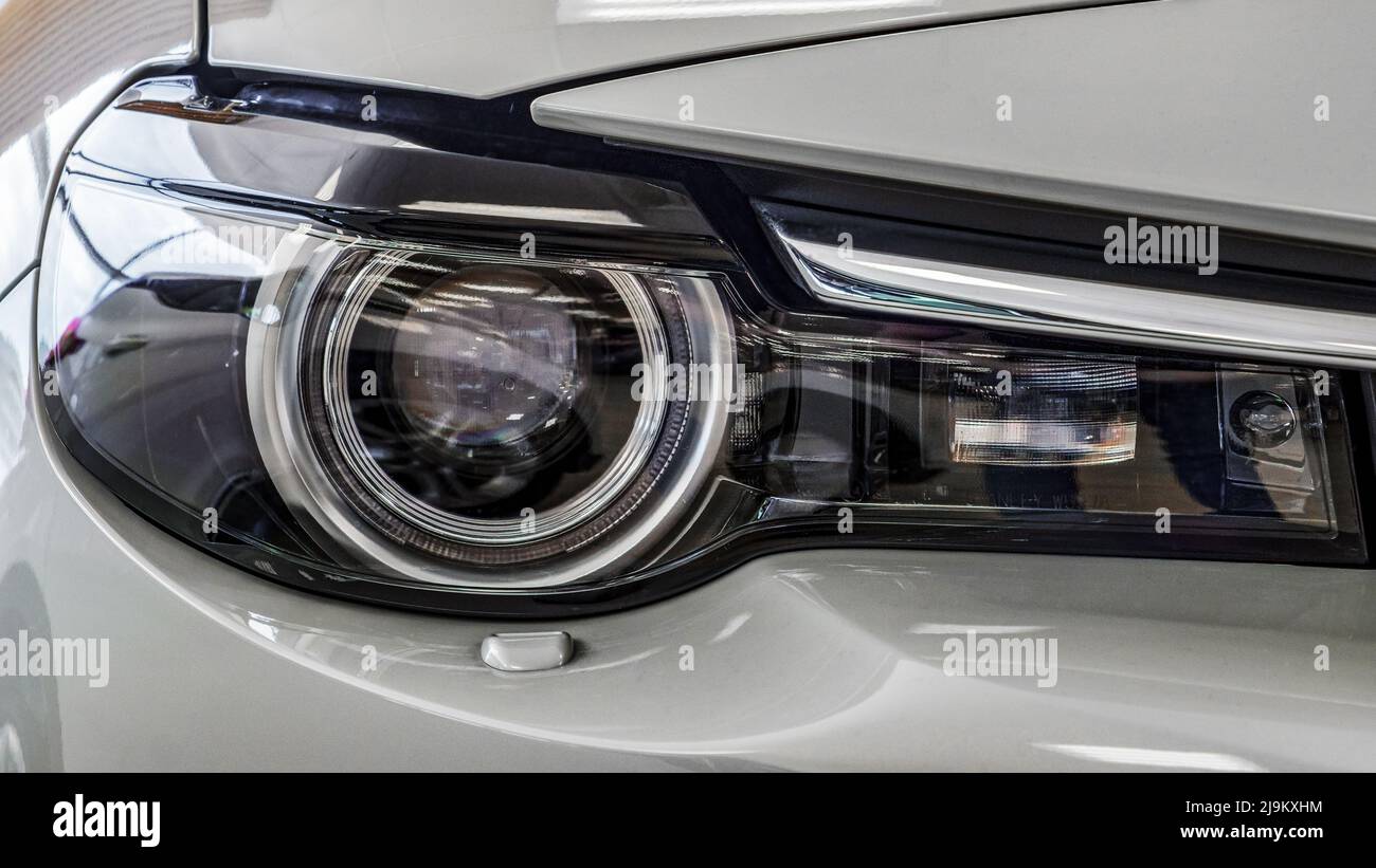 Front headlight of a modern car. Light gray color. Close-up Stock Photo ...