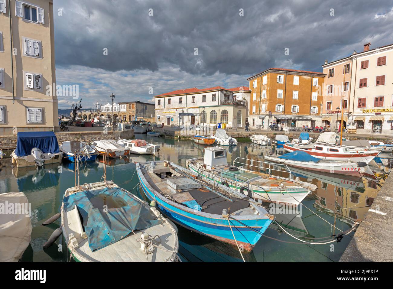 Storm clouds over boats moored in the Molo Cristoforo Colombo harbour ...