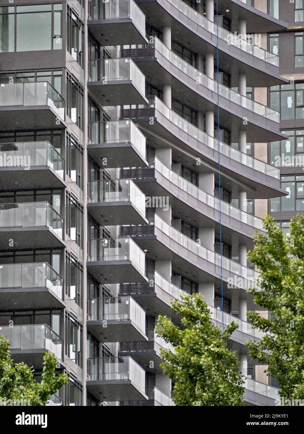 New high-rise building under construction on rainy day Stock Photo - Alamy