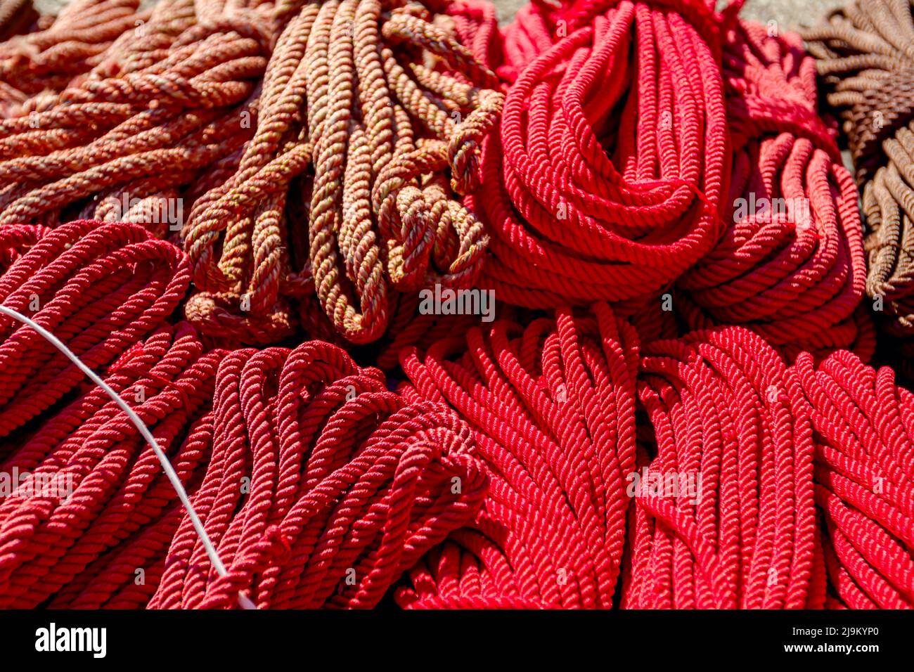 Close up shot of heap of braided hemp ropes made for sale at outdoor ...