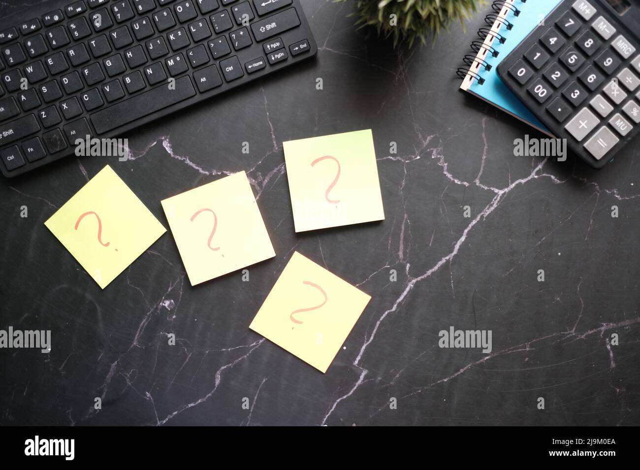 high angle view of question mark on paper on office desk Stock Photo ...