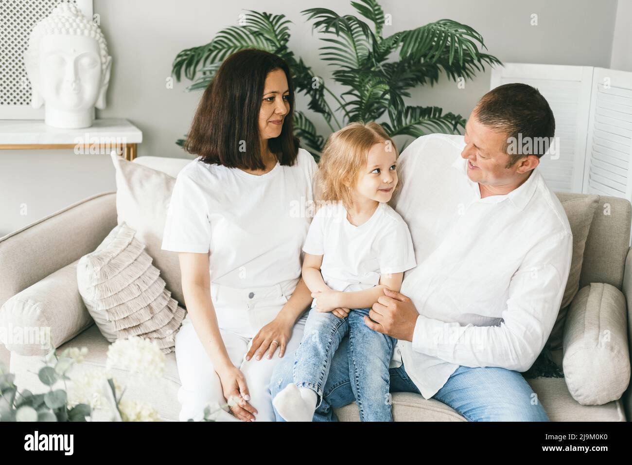 Happy family of three at home Stock Photo - Alamy