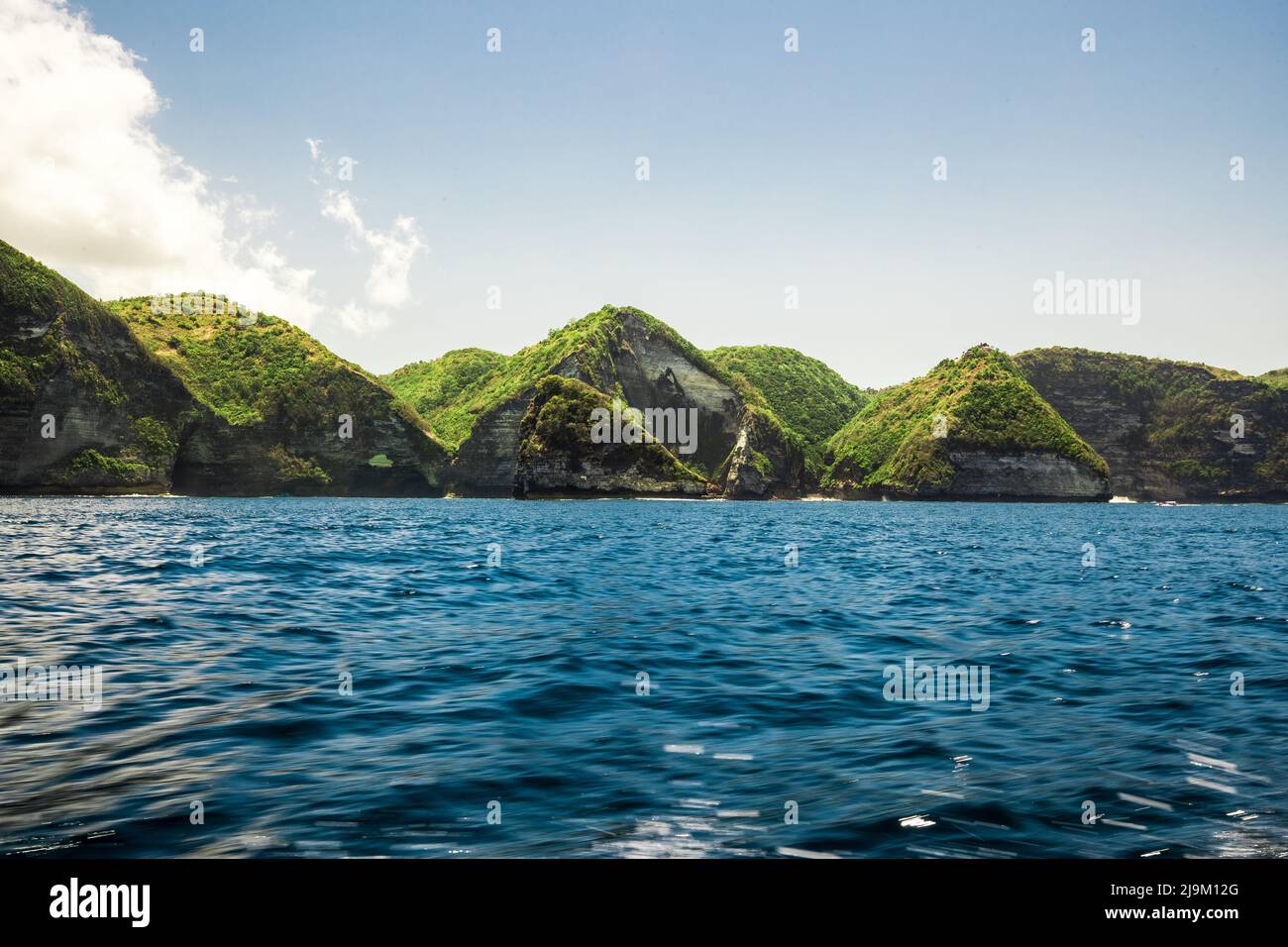 wide landscape of large triangular mountain hills of Nusa Penida ...