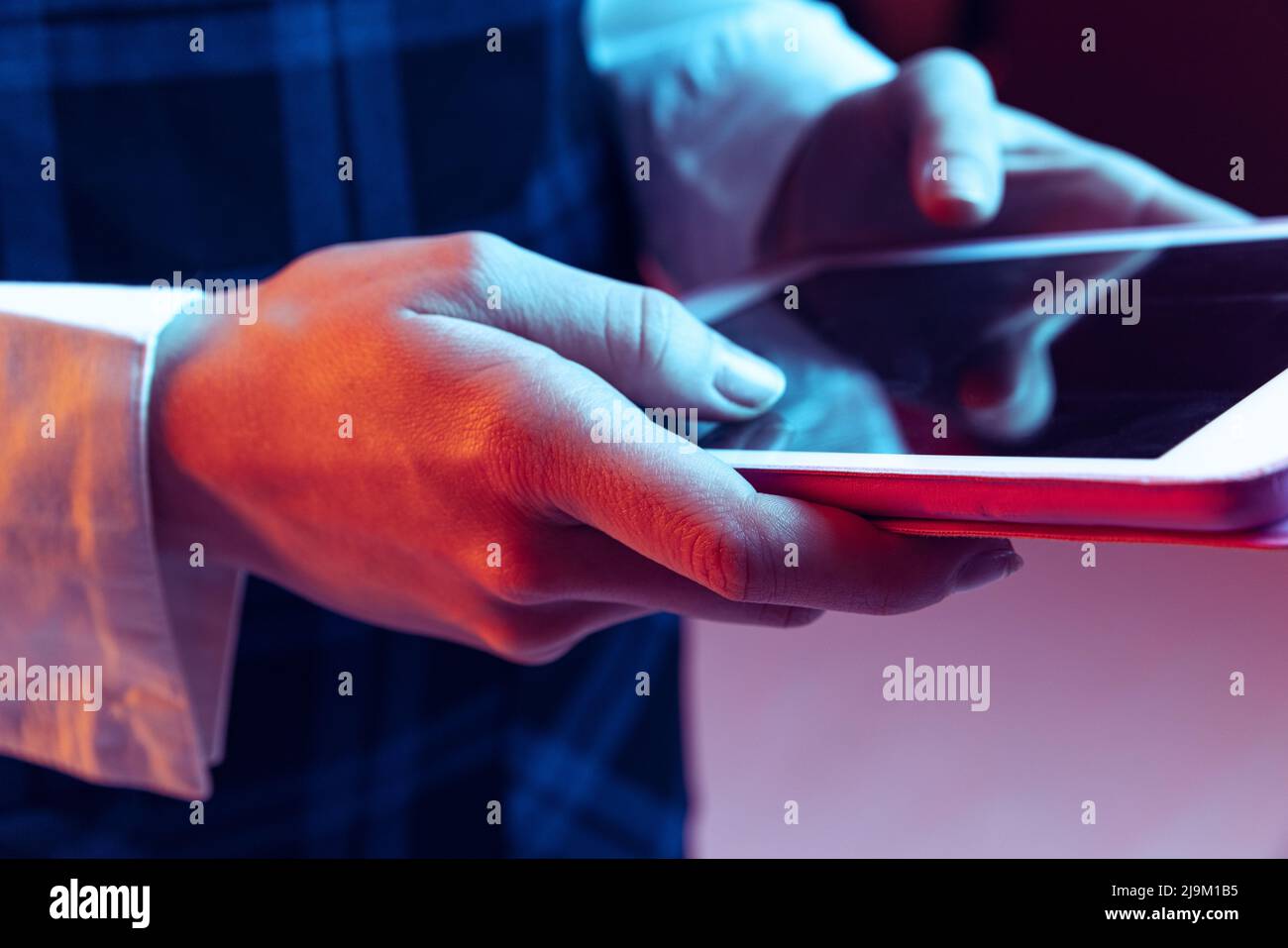 Close-up image of female hands and tablet, typing messages, searching ...