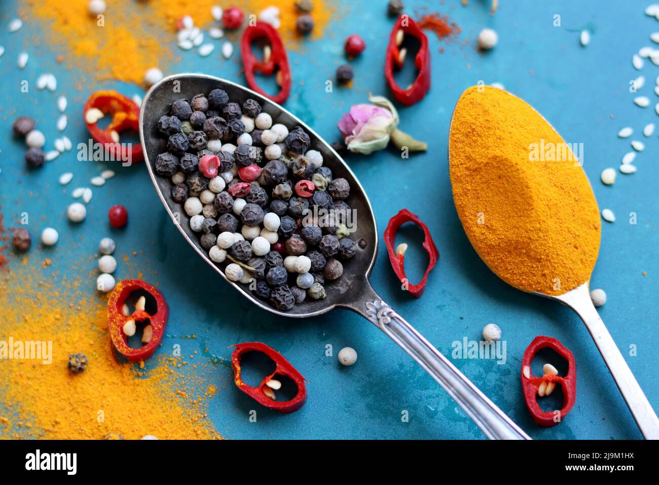 Still life with silver spoons, turmeric , paprika powder, bay leaf and ...