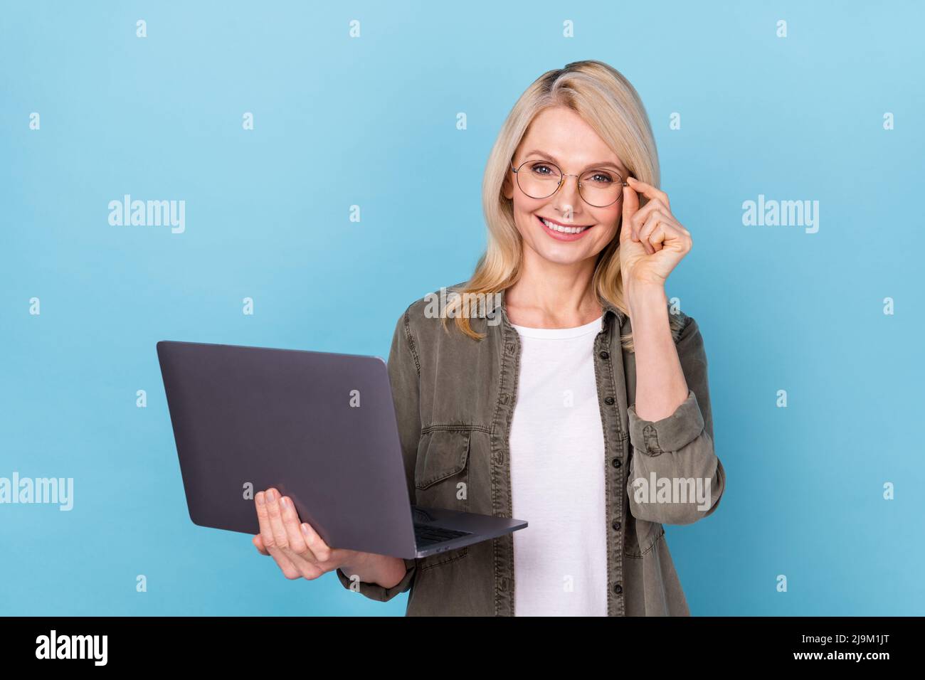 Photo of successful aged lady agent hold netbook enjoy teaching ...