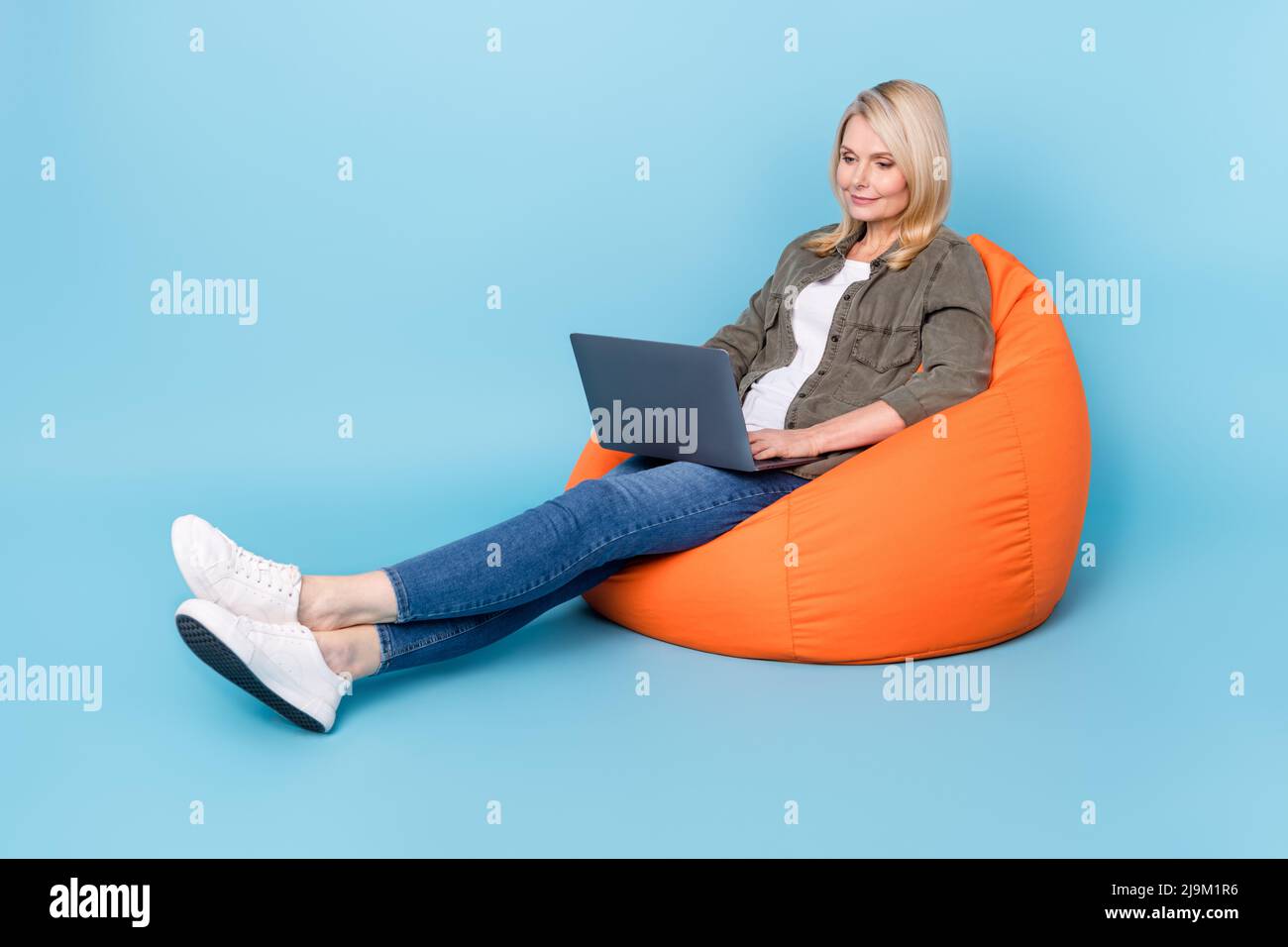 Full length portrait of satisfied person sit comfy bag use wireless ...