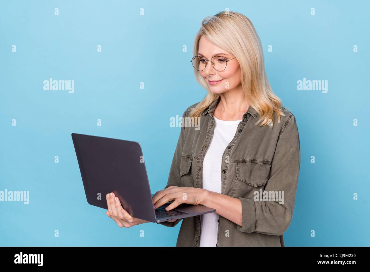 Photo of smart old lady ceo expert use device netbook speak wifi ...