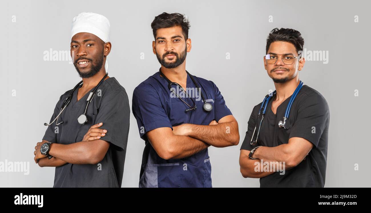 attractive medical team standing together over light gray background ...