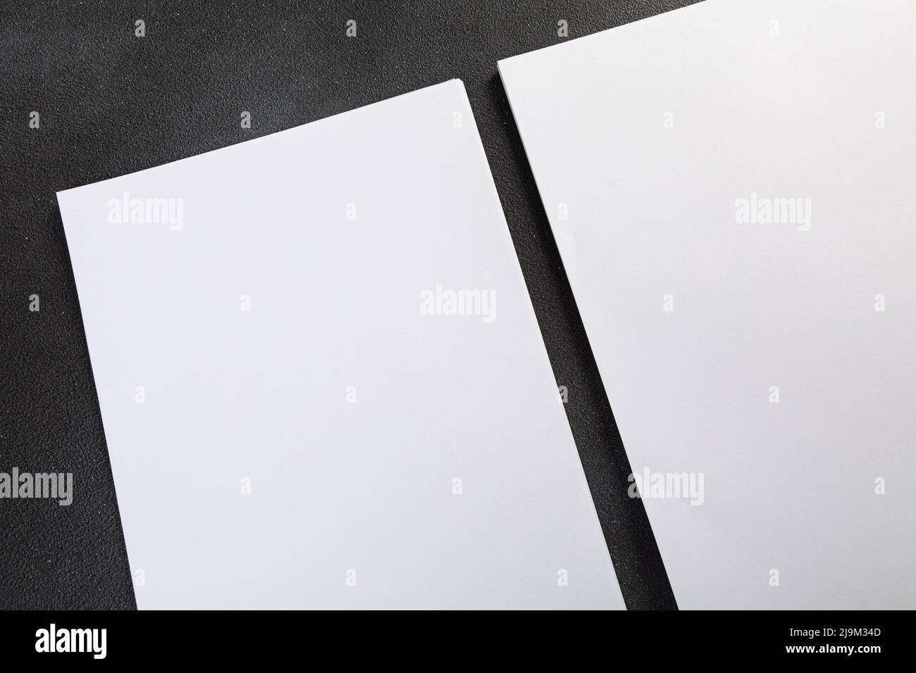 White business card sheet of paper a4 stack on a dark table. Clean ...
