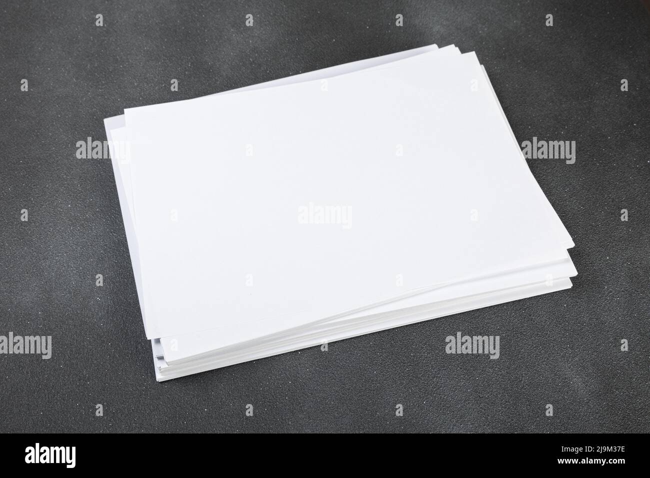 Blank flyer poster A4 paper isolated on dark gray to replace your ...
