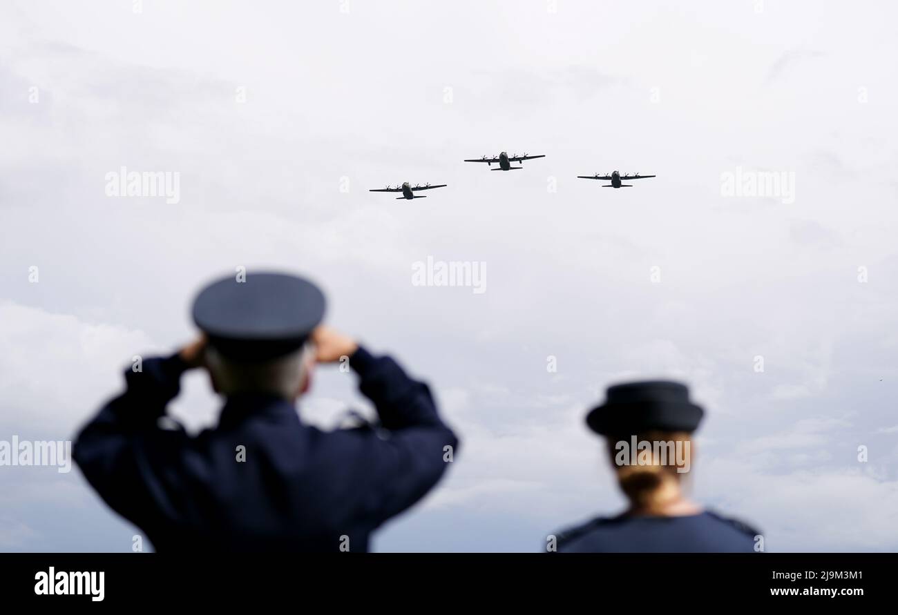 Three C-130 Hercules are seen overhead as aircraft from the Royal Navy ...