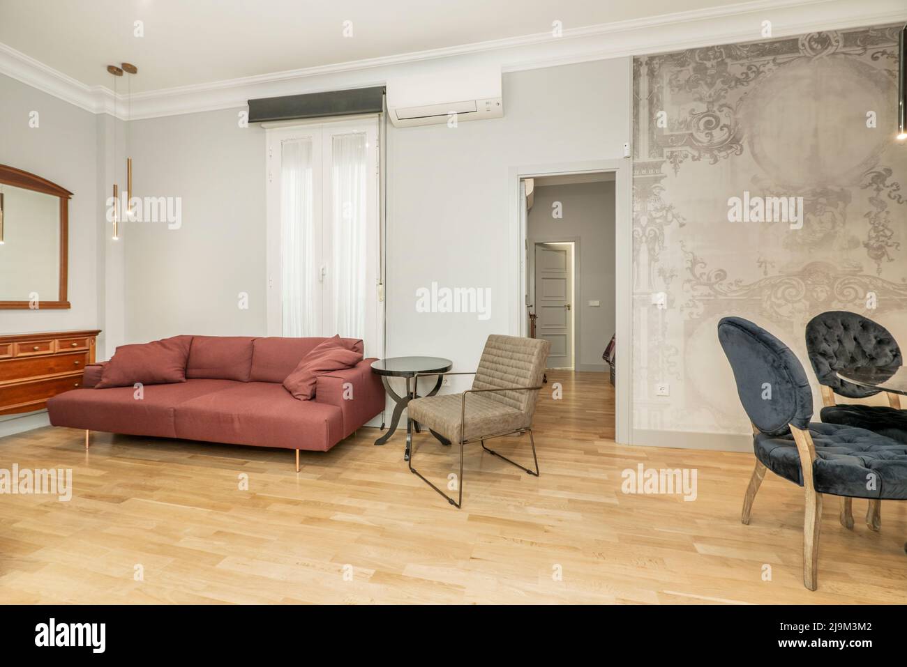 Apartment living room with burgundy three-seater sofa, vintage ...