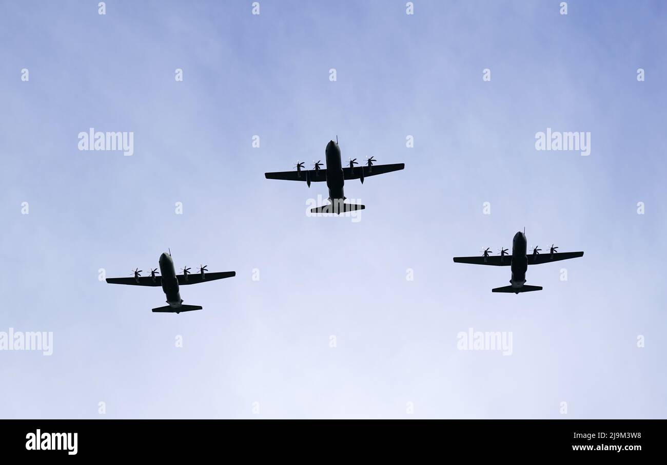 Three C-130 Hercules are seen overhead as aircraft from the Royal Navy ...