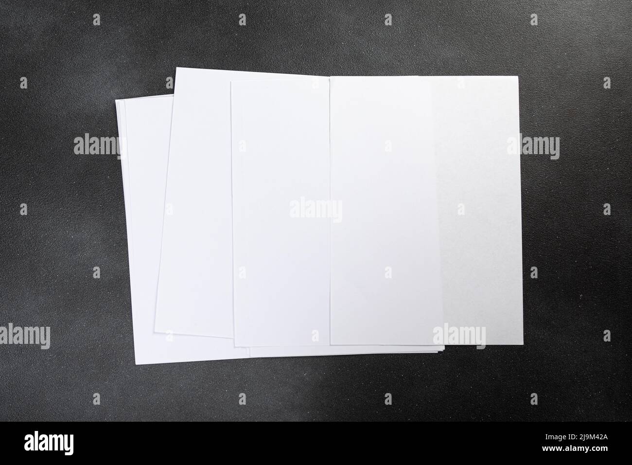 White business card sheet of paper a4 stack on a dark table. Clean ...