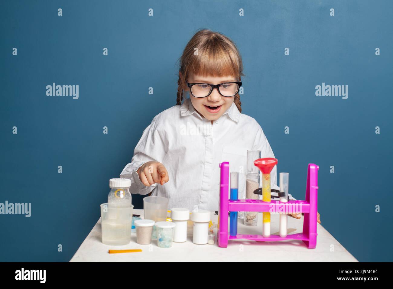 Happy child girl student doing science experiments in school laboratory ...