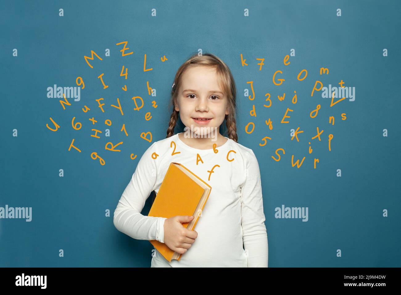 Happy clever kid student school girl holding book on blue background ...