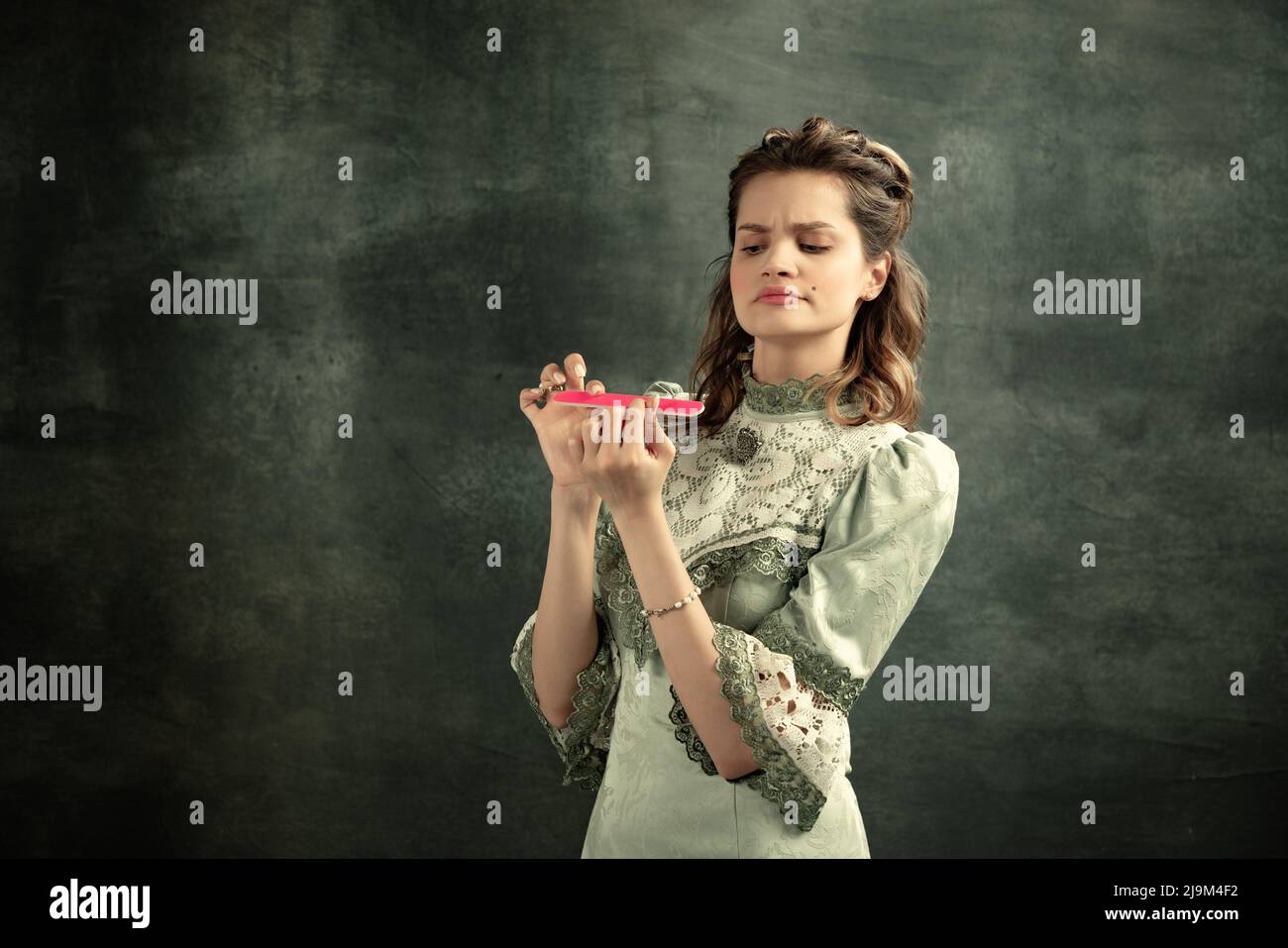 Vintage portrait of young beautiful girl in gray dress of medieval ...