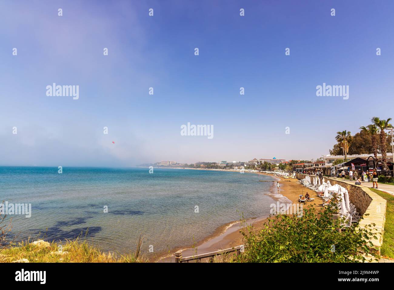 Sandy beach of Mediterranean coast at historic city of Side in Turkey ...