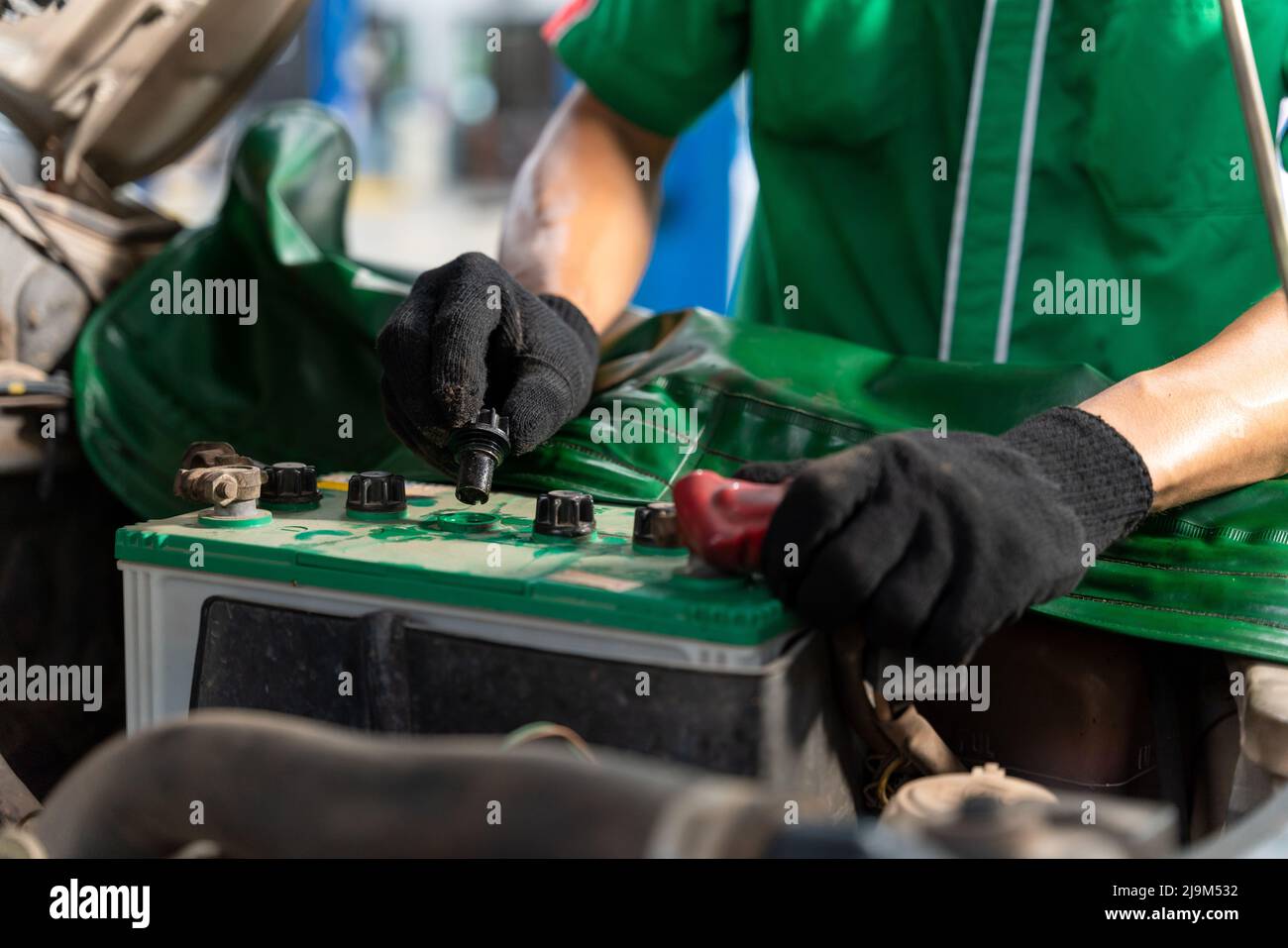 Close up hand of Auto mechanic is about to repair battery for the ...