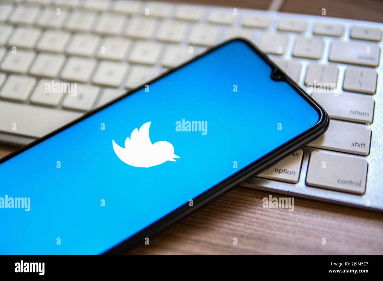 In this photo illustration, a Twitter logo seen displayed on a ...