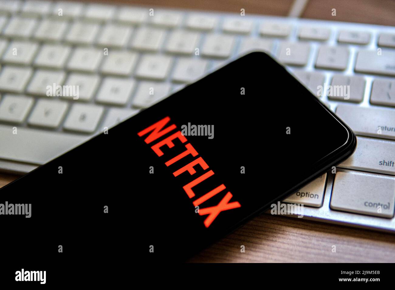 In this photo illustration, a Netflix logo seen displayed on a ...