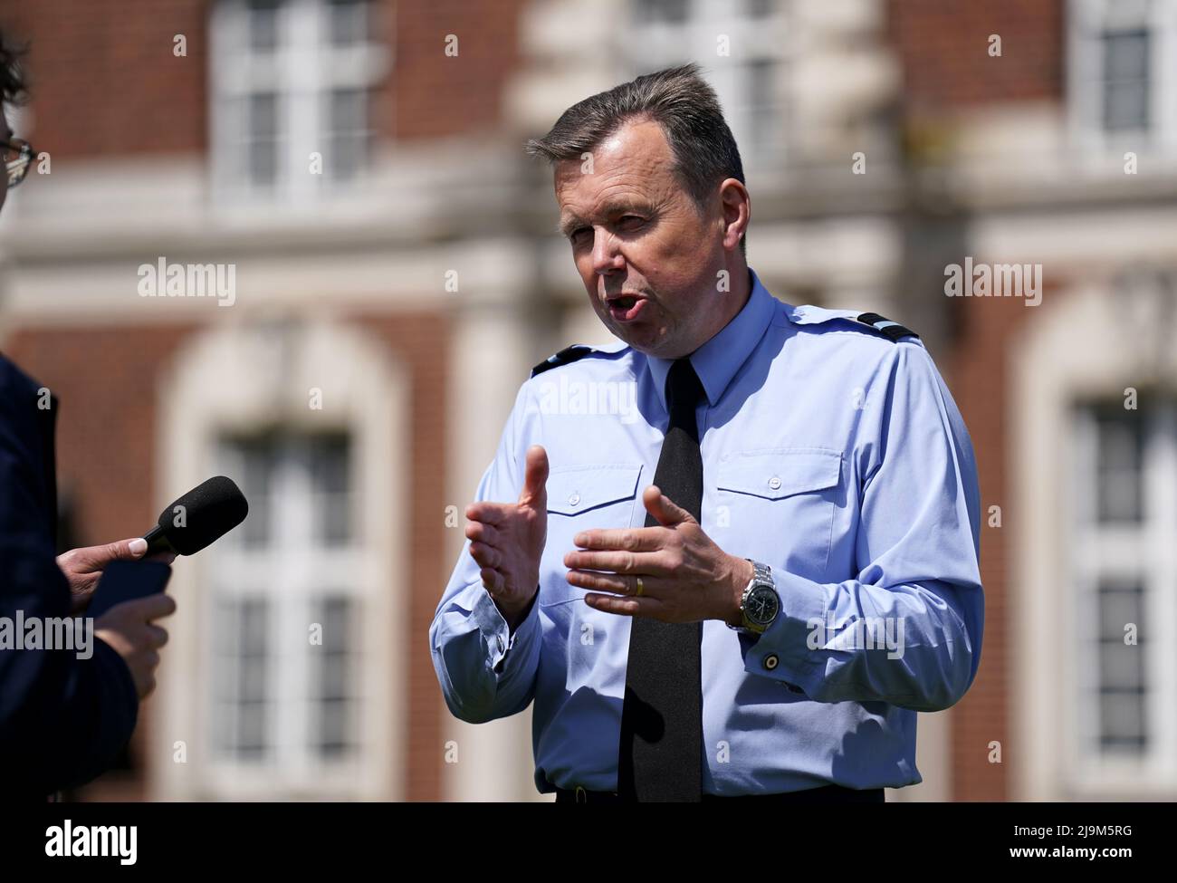 RAF Senior Commander Mike Baulkwill speaks outside College Hall as ...
