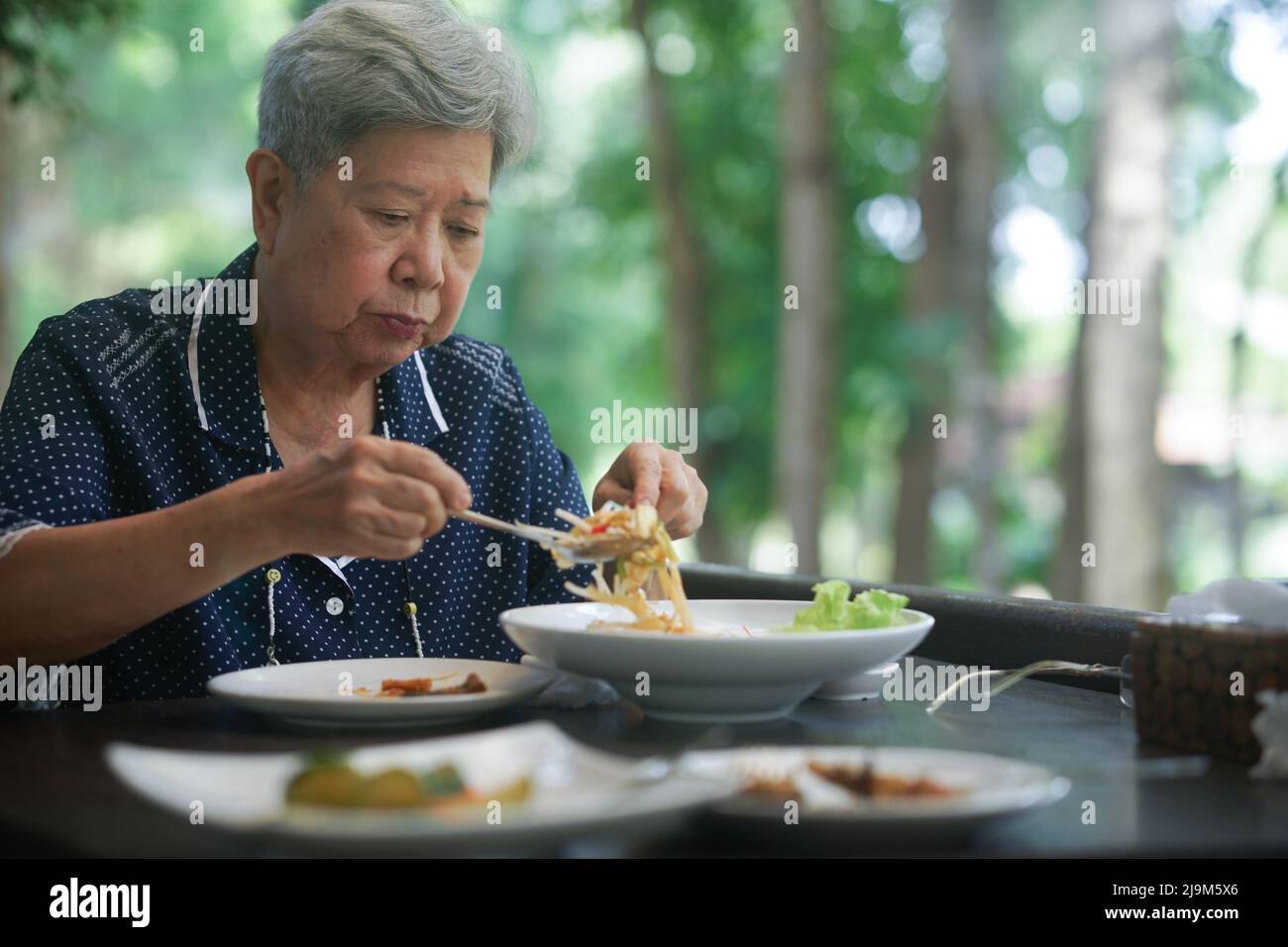 Old lady eating breakfast hi-res stock photography and images - Alamy