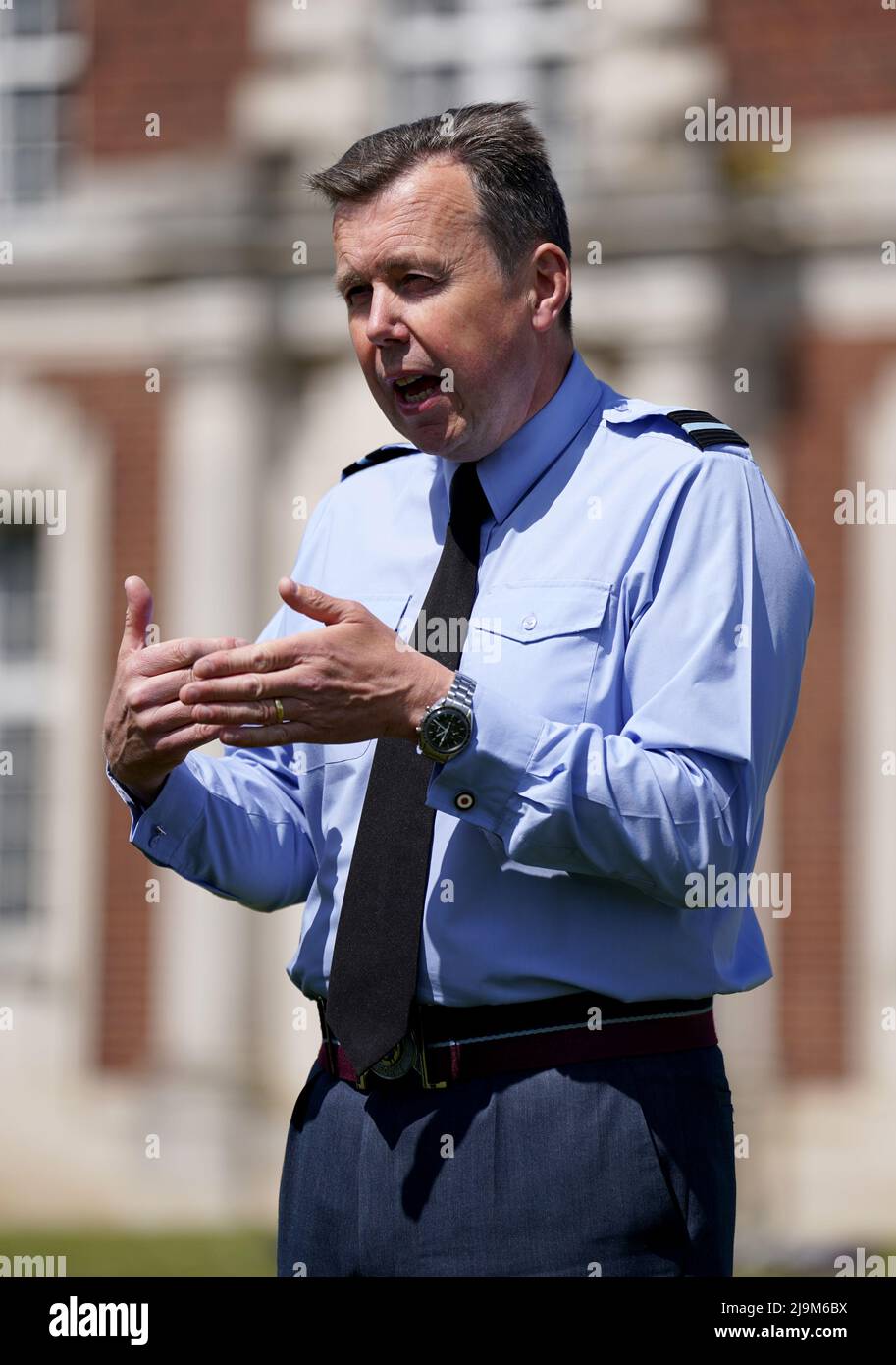 RAF Senior Commander Mike Baulkwill speaks outside College Hall as ...
